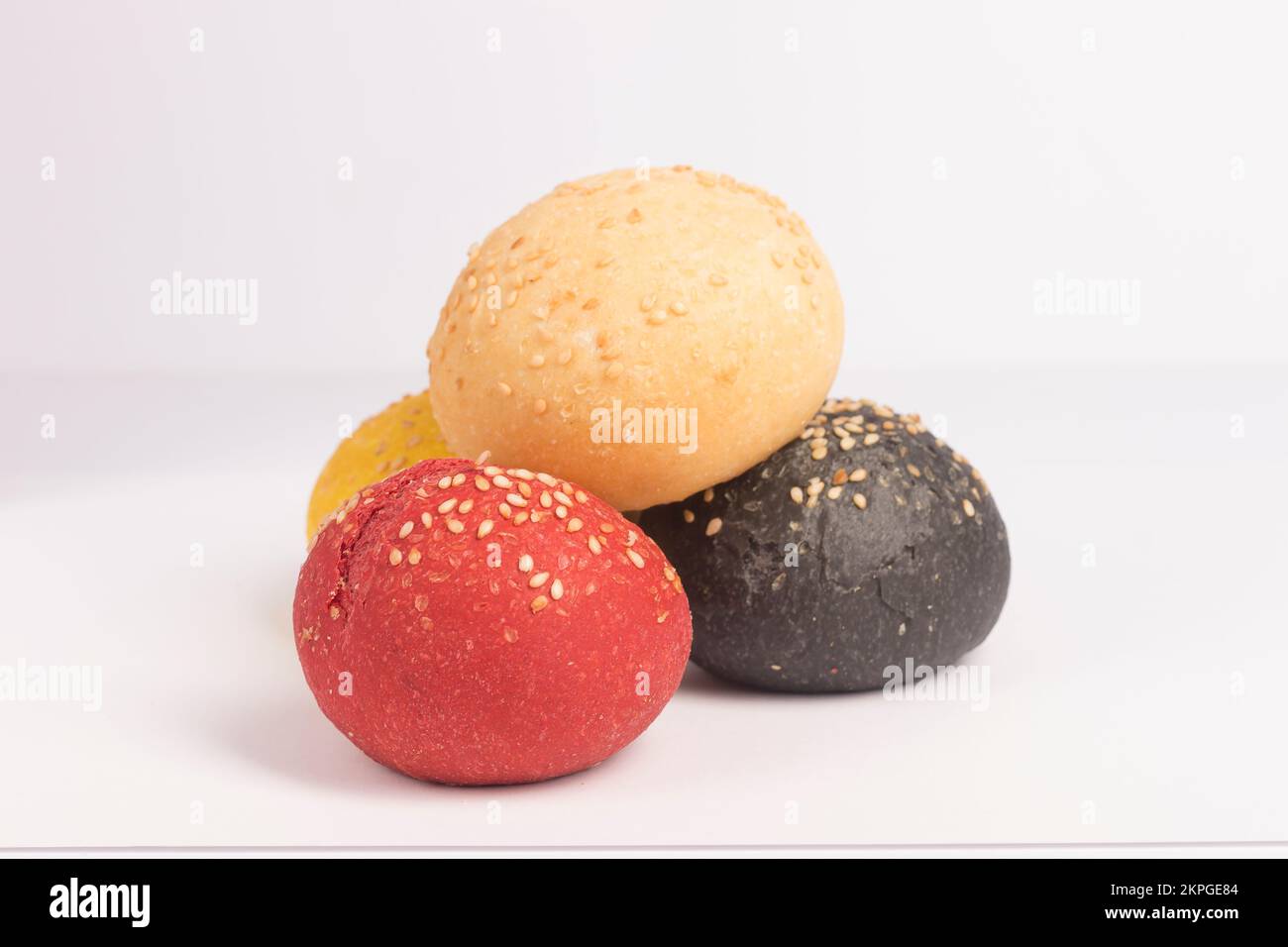 Colorful seasoned bread resting on a white background Stock Photo - Alamy