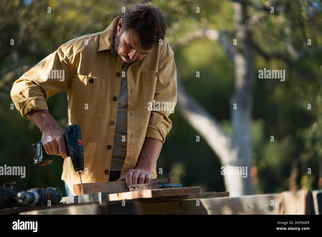 Smiling craftsman working drill hi-res stock photography and images - Alamy