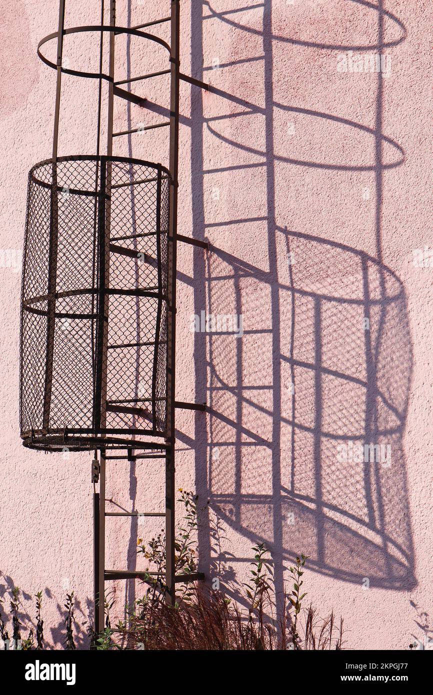 Metal ladder with shadow on the wall Stock Photo - Alamy