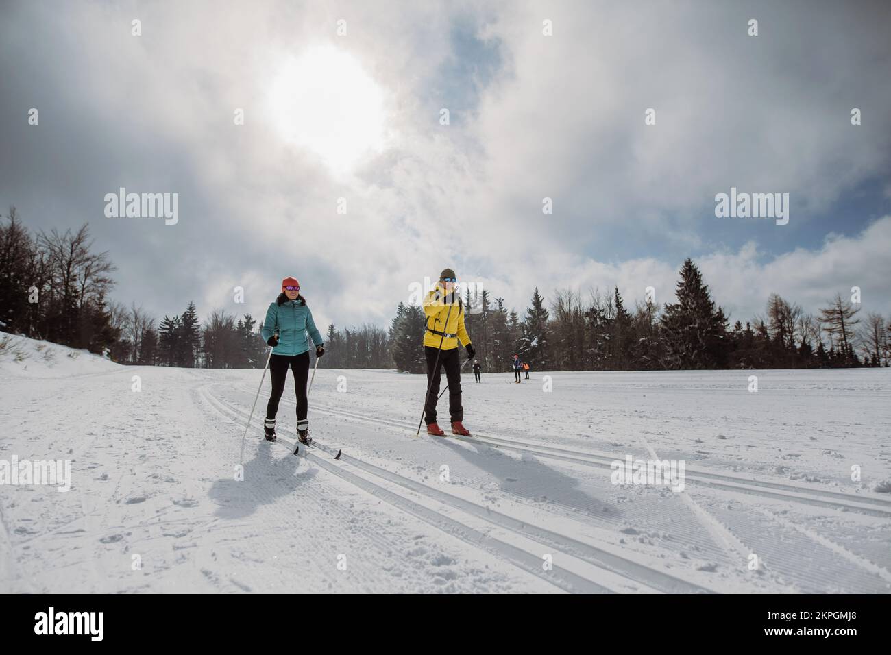 Senior couple skiing together in the middle of forest Stock Photo - Alamy