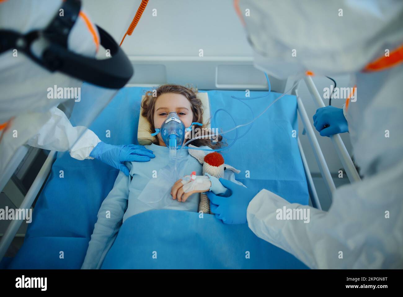 Close-up of little girl with infection disease lying in hospital room ...