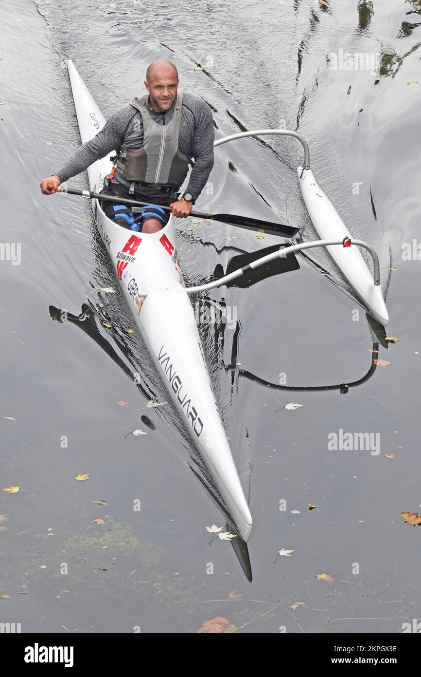Aerial view man canoeist paddling in Italian Allwave Vanguard outrigger ...