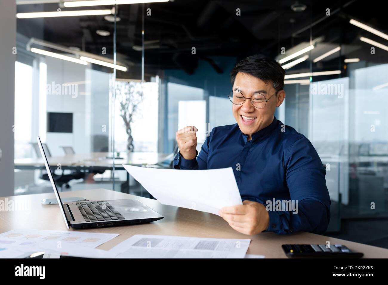 Businessman in glasses celebrating documents hi-res stock photography ...