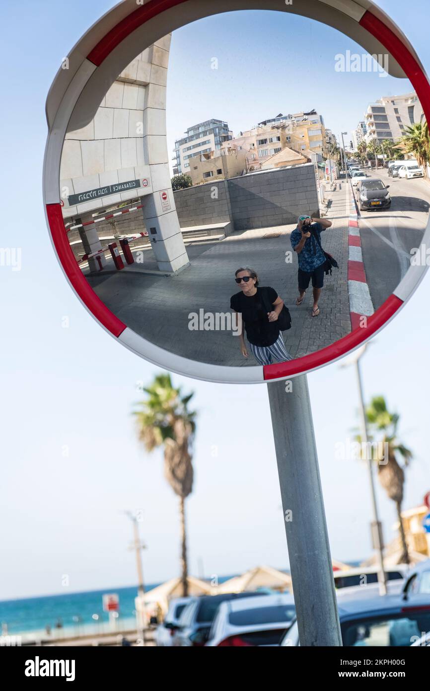 Photographer shooting into traffic mirror of partner, Tel Aviv Stock ...