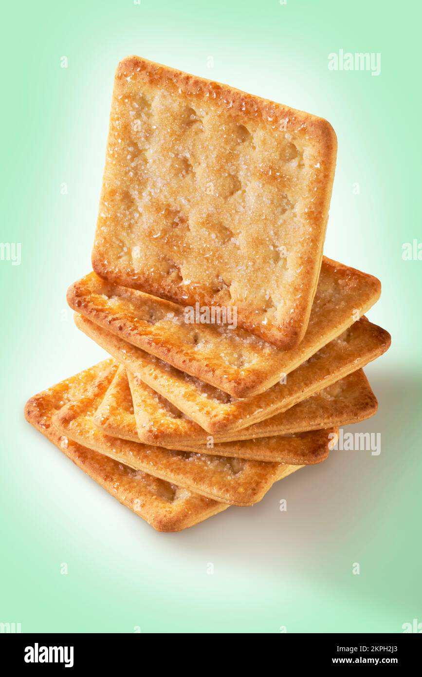 a pile of seven sugar-coated sweet crackers with one standing on top ...
