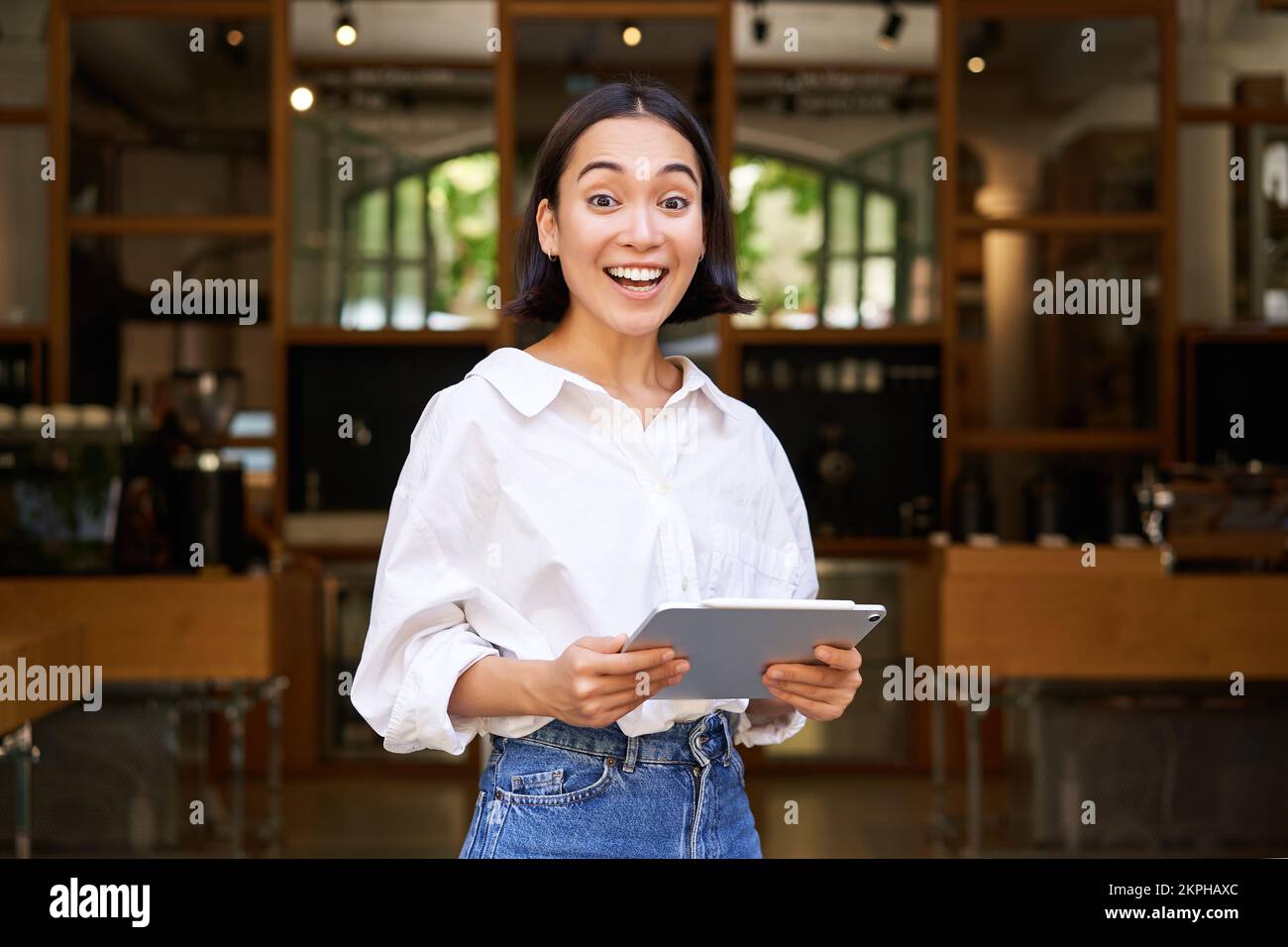 Smiling beautiful waitress, businesswoman with digital tablet, laughing ...