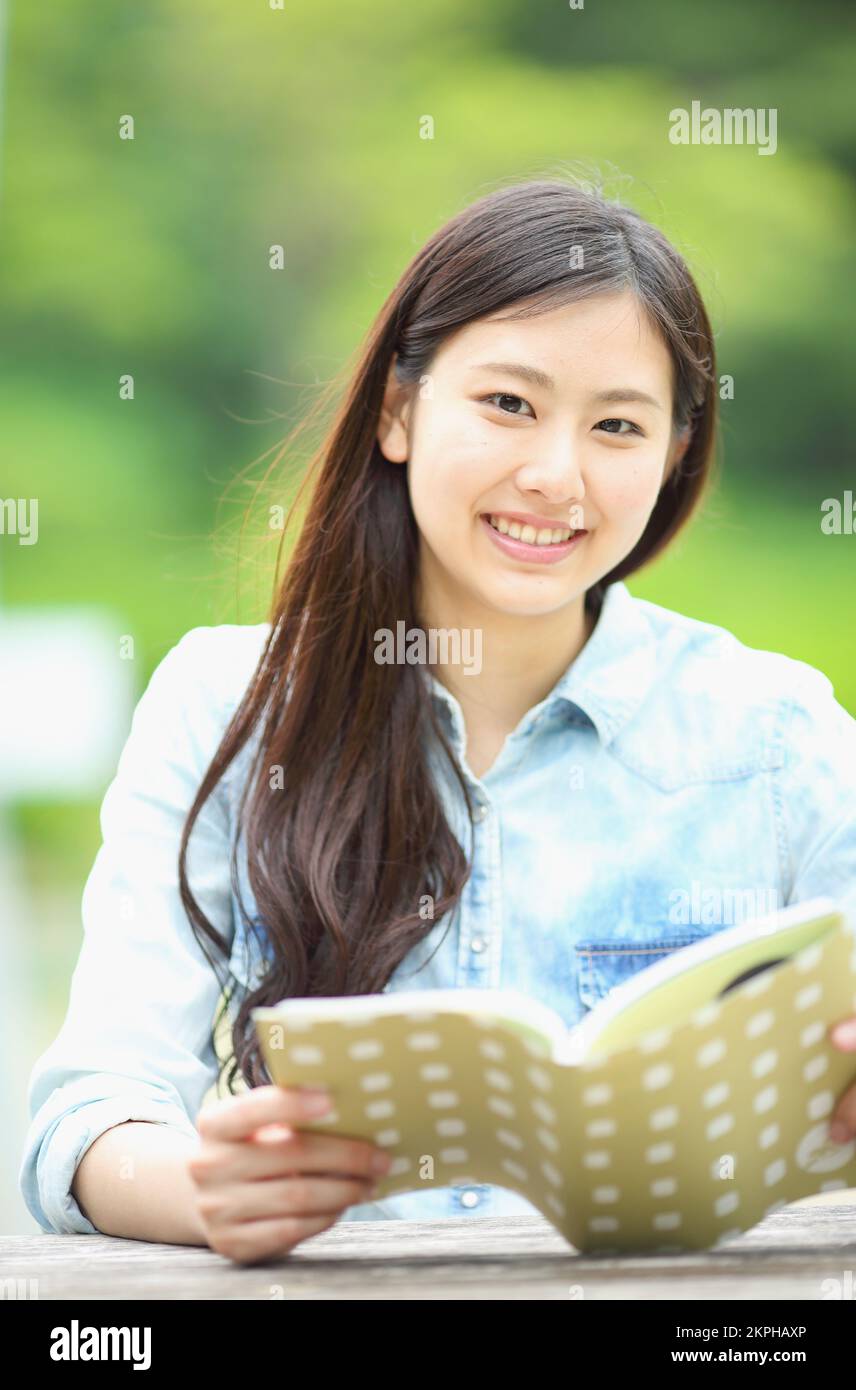 Japanese woman reading a book in the outdoors Stock Photo - Alamy