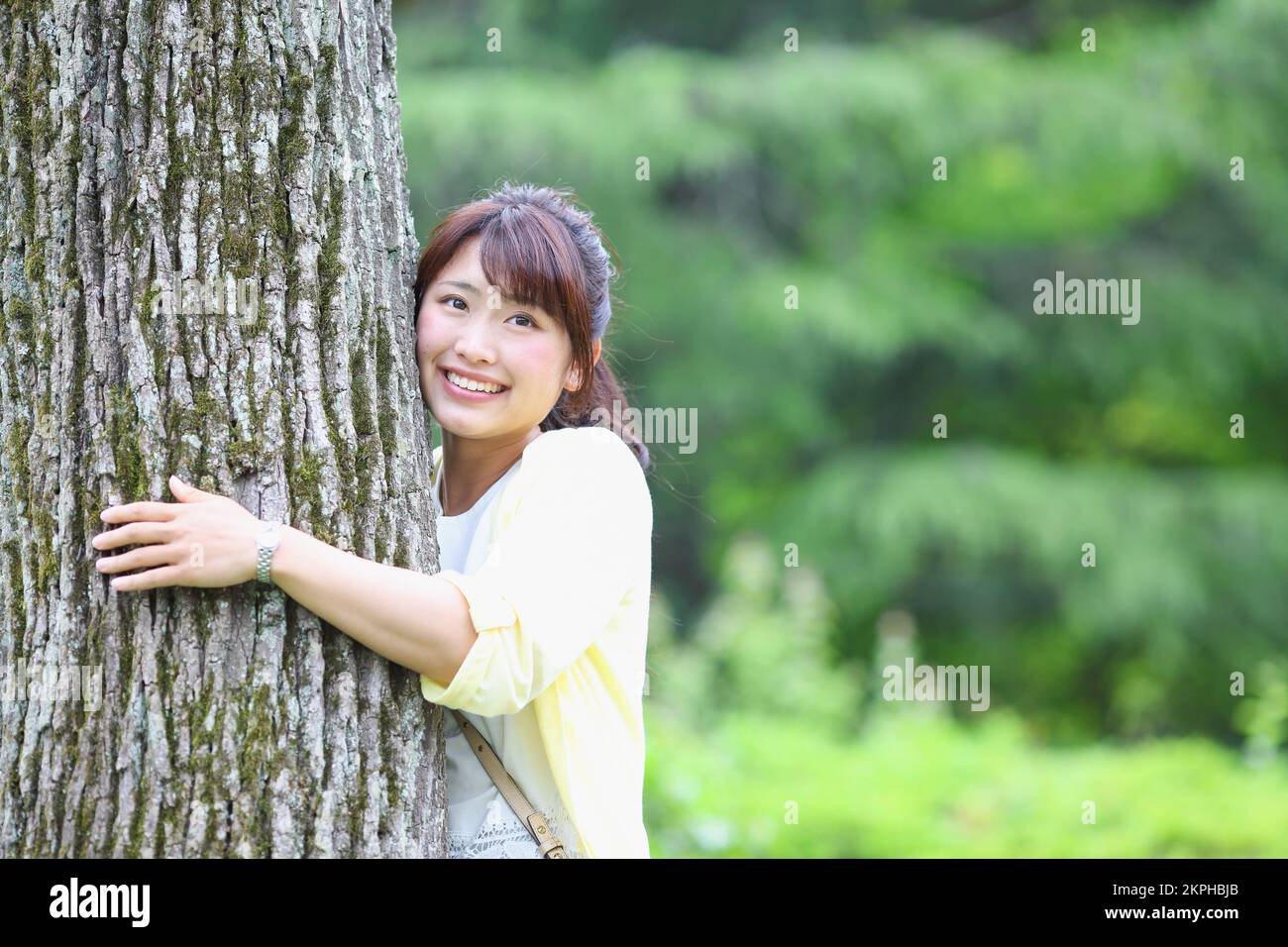 Japanese woman hugging a tree Stock Photo - Alamy