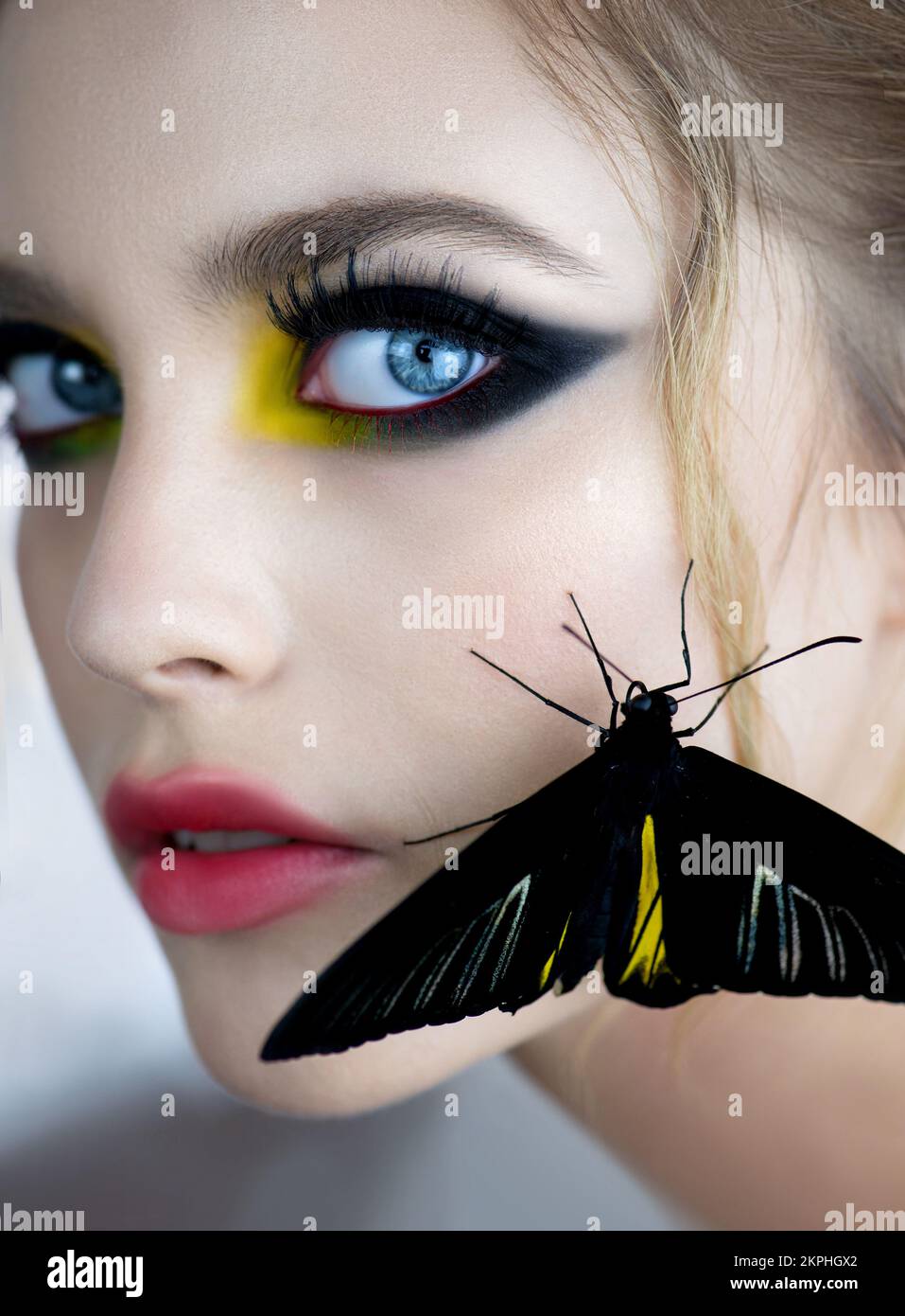 Beautiful young woman with perfect skin and bright yellow makeup posing ...