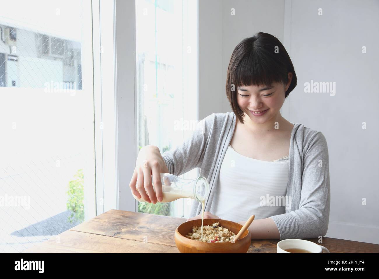 Young Japanese woman having breakfast Stock Photo - Alamy