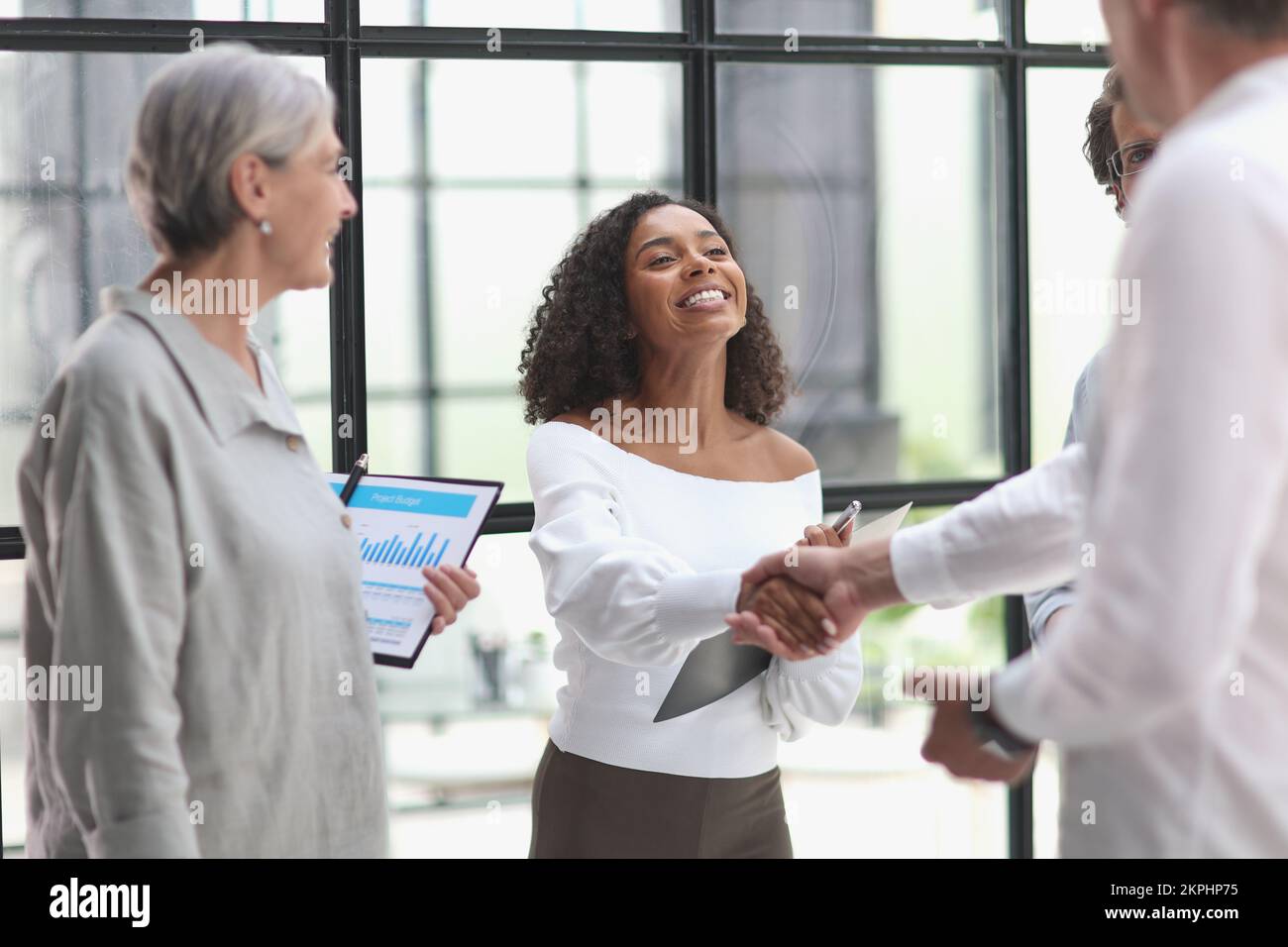 Group of business workers standing together shaking hands at the office ...