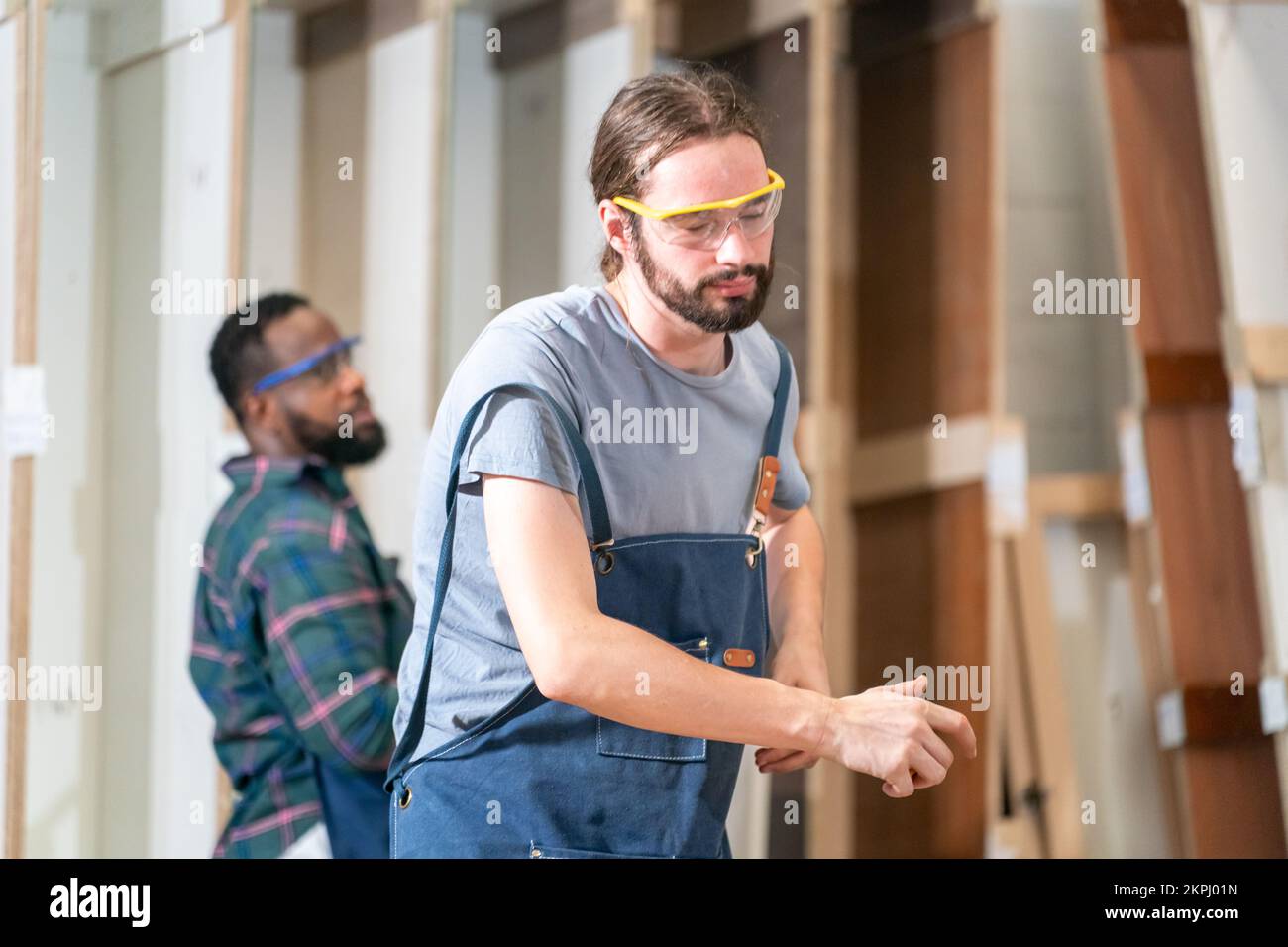 Carpenter working on the woodworking desk and furniture handmade with ...