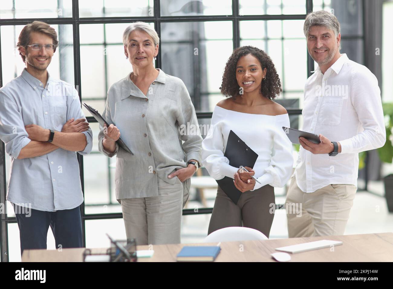 A group of young modern people in smart casual clothes, studying while ...