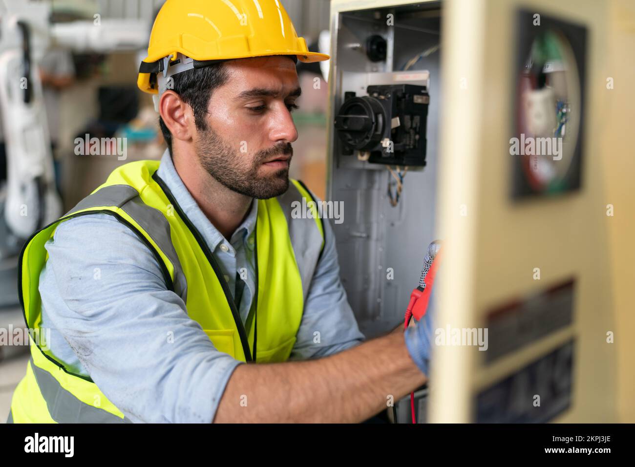 Robotics engineer working on maintenance of modern robotic arm in ...
