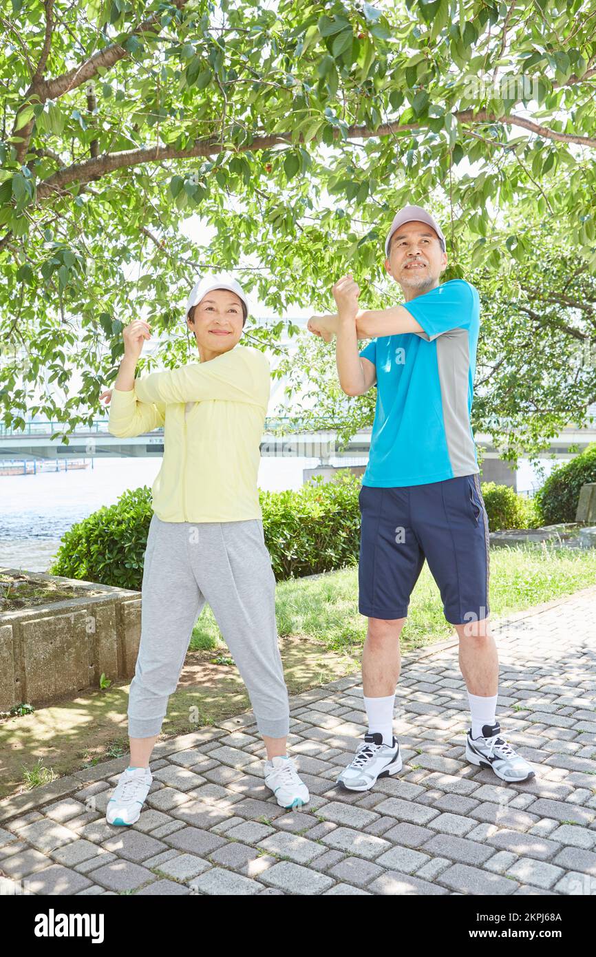 Japanese senior couple doing warm up exercises Stock Photo - Alamy