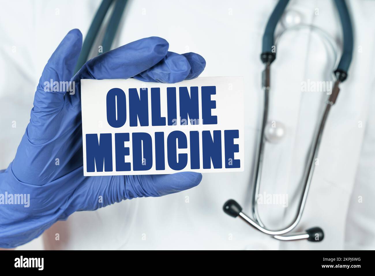 Medicine concept. The doctor holds a business card that says - ONLINE ...