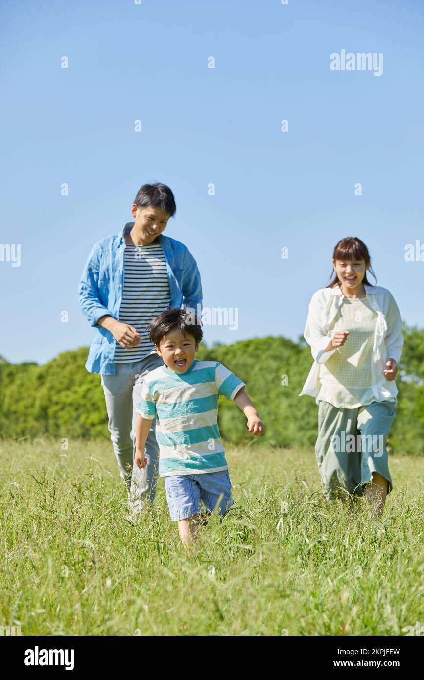 Japanese family running in the field Stock Photo - Alamy
