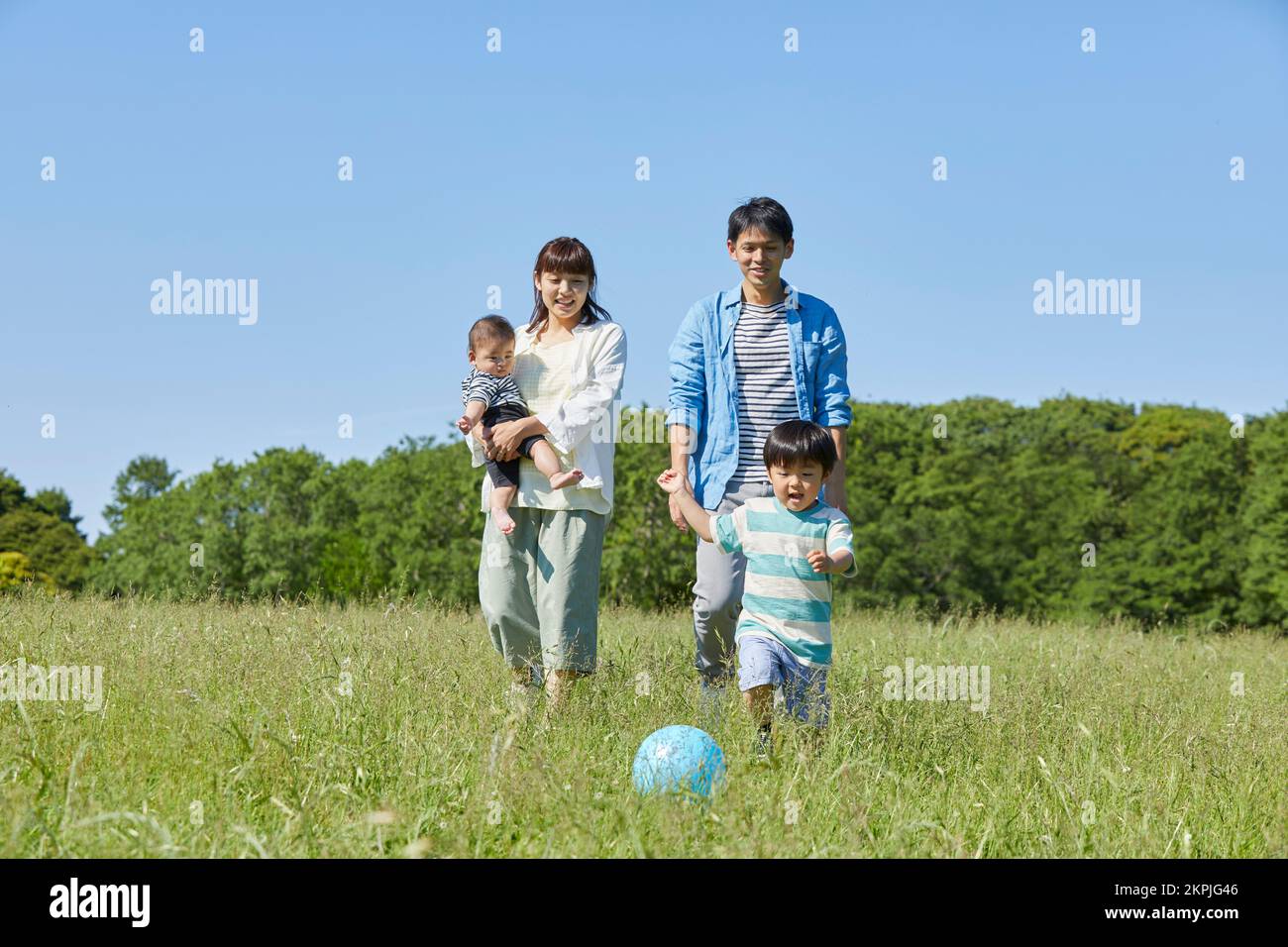 Japanese parents watching over child playing ball Stock Photo - Alamy