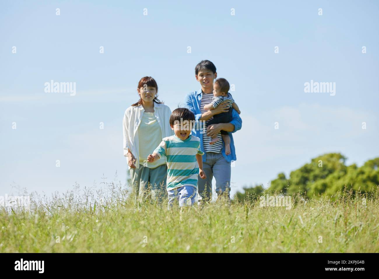 Japanese parents watching over a running child Stock Photo - Alamy