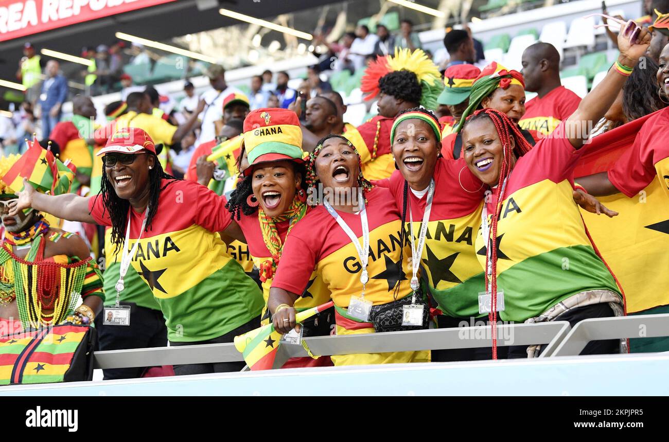 Fans clad in the colors of the Ghana flag pose for a photo ahead of a ...