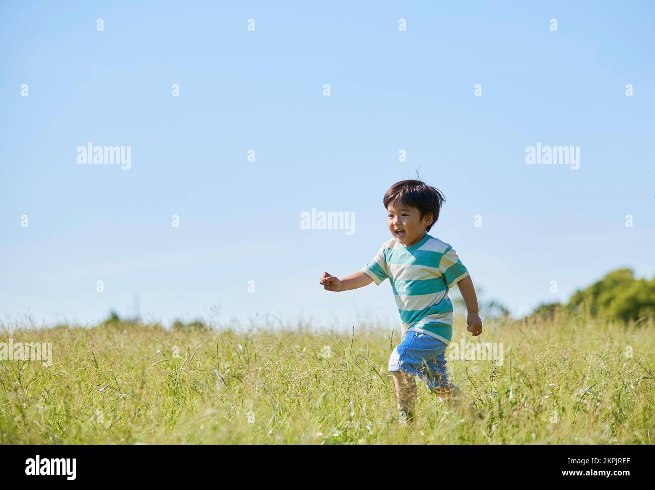 Japanese boy running in the field Stock Photo - Alamy