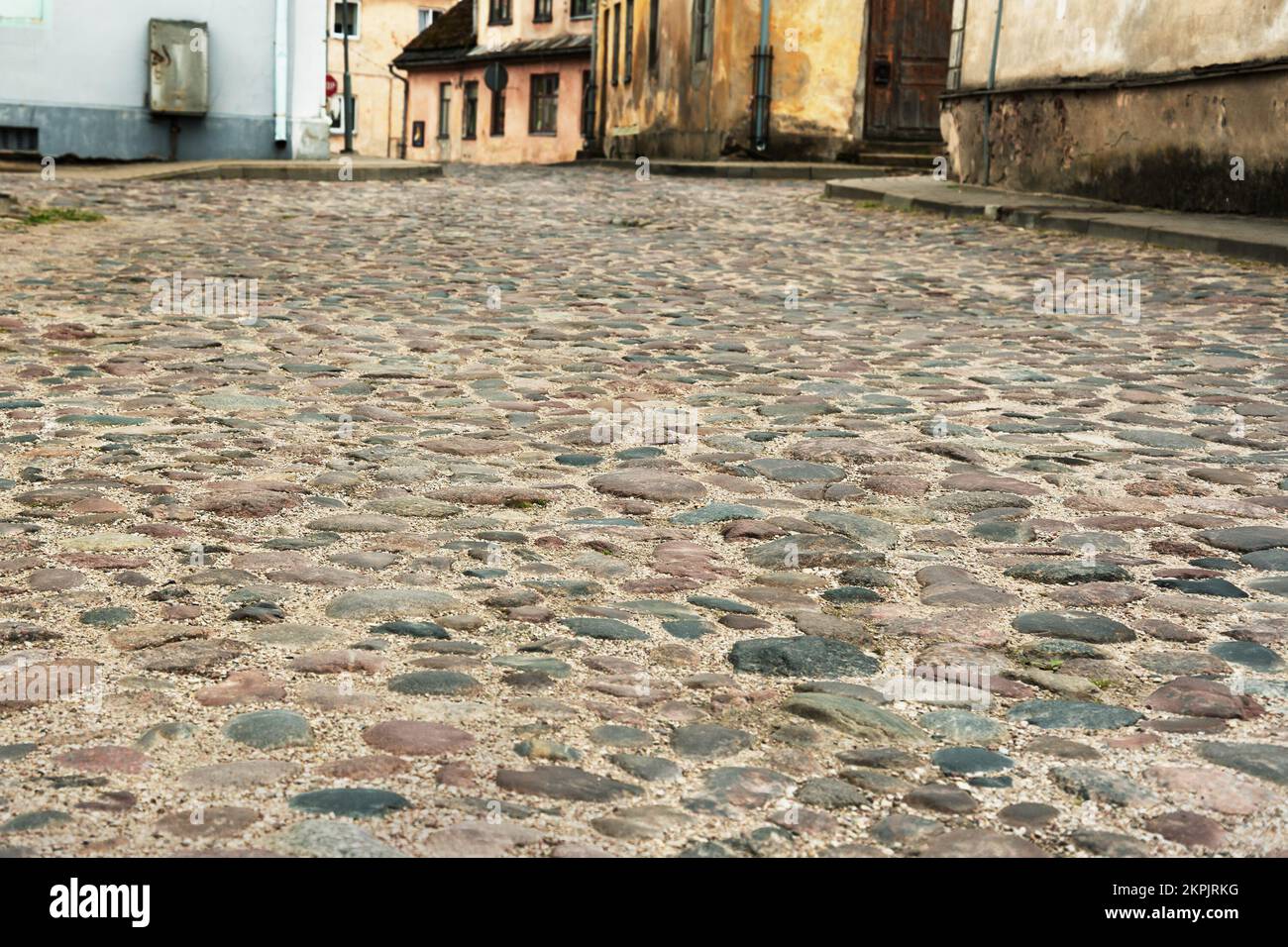 View to a street in small town with cobblestone road Stock Photo - Alamy