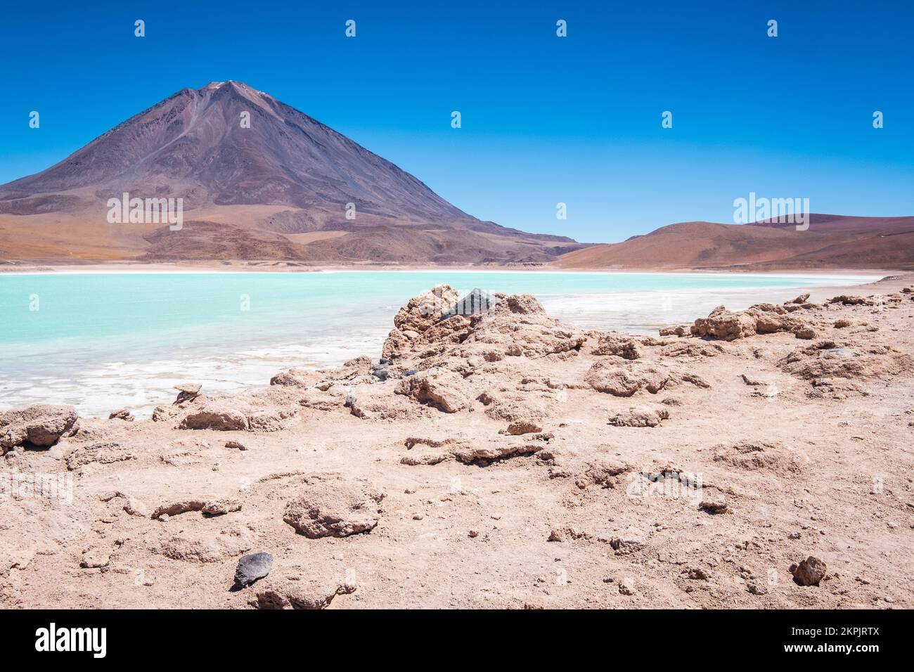 Volcanic rocks at the Laguna Verde (Green Lagoon) with the Licancabur ...