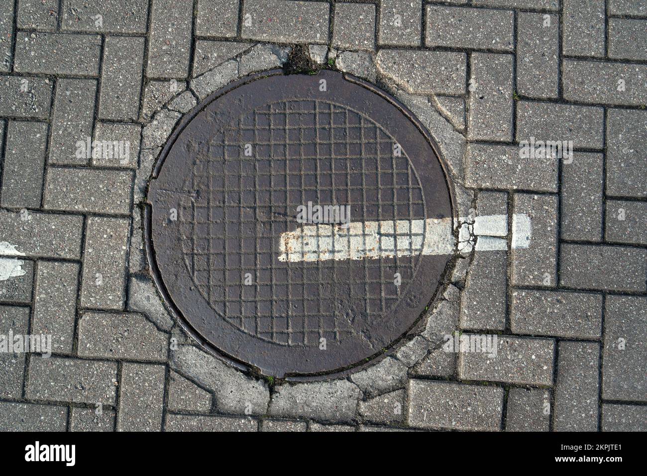 Sewer hatch with marking strip Stock Photo - Alamy
