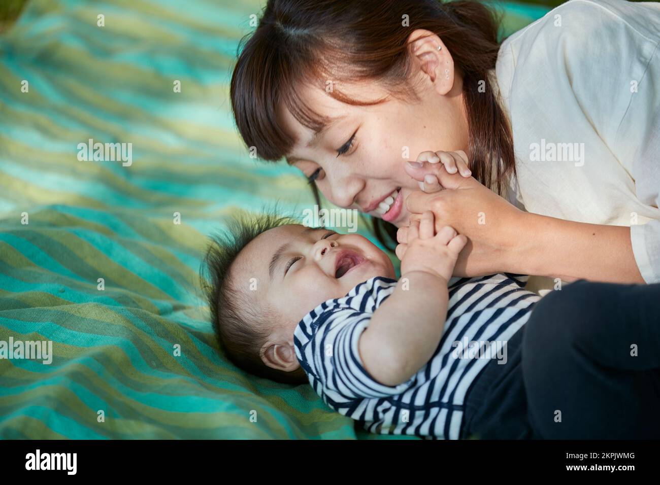 Japanese mother cuddling with her baby Stock Photo - Alamy