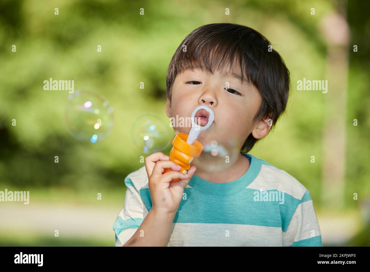 Japanese boy blowing bubbles Stock Photo - Alamy