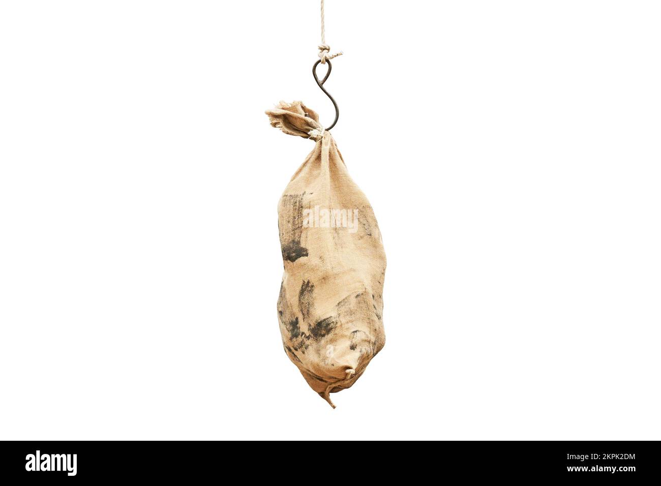 Retro canvas bag is lifted on a rope with a hook, isolated on a white ...