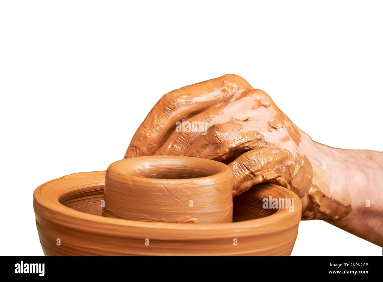 A man in old medieval Byzantine clothes sits behind a vintage potter's ...