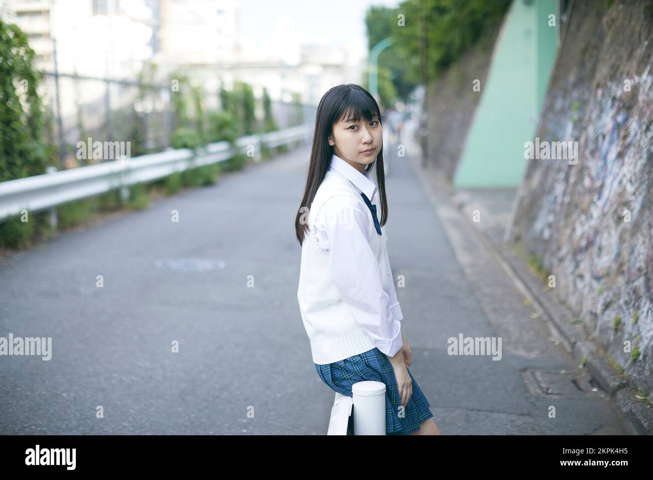 Teenager girl sitting on rail hi-res stock photography and images - Alamy