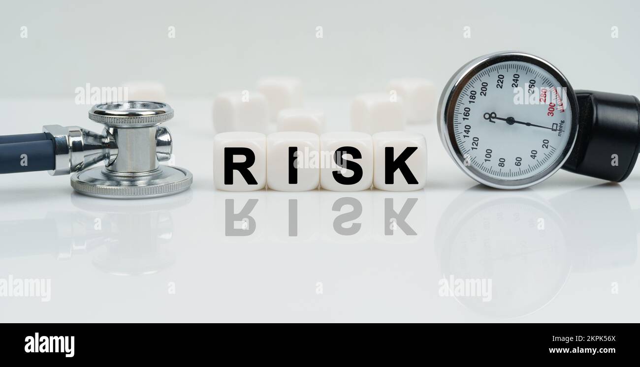 Medicine concept. On a reflective white surface lies a stethoscope and ...