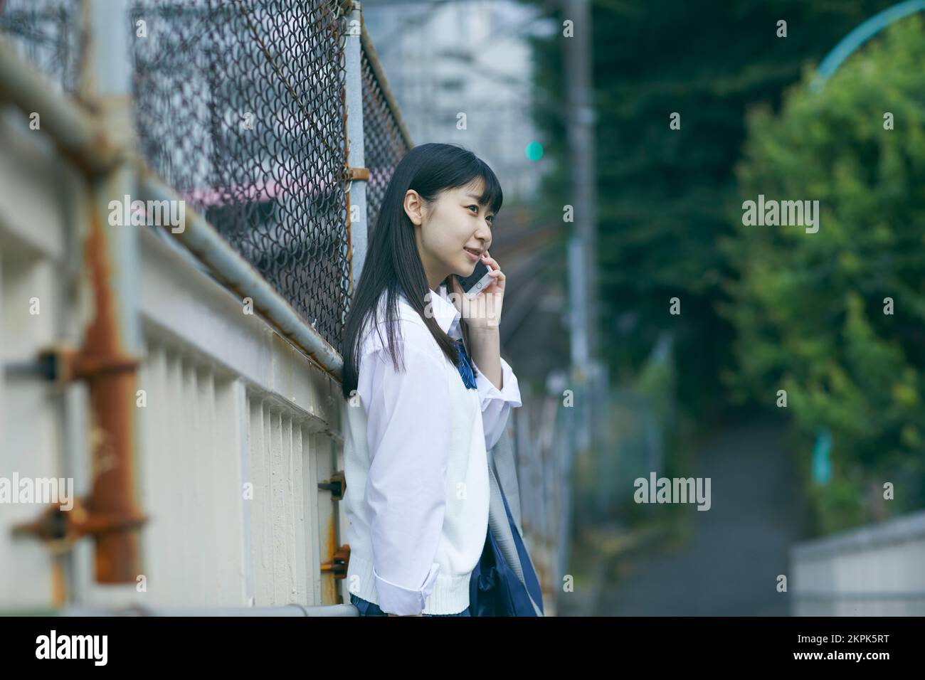 Japanese high school girl making a phone call Stock Photo - Alamy