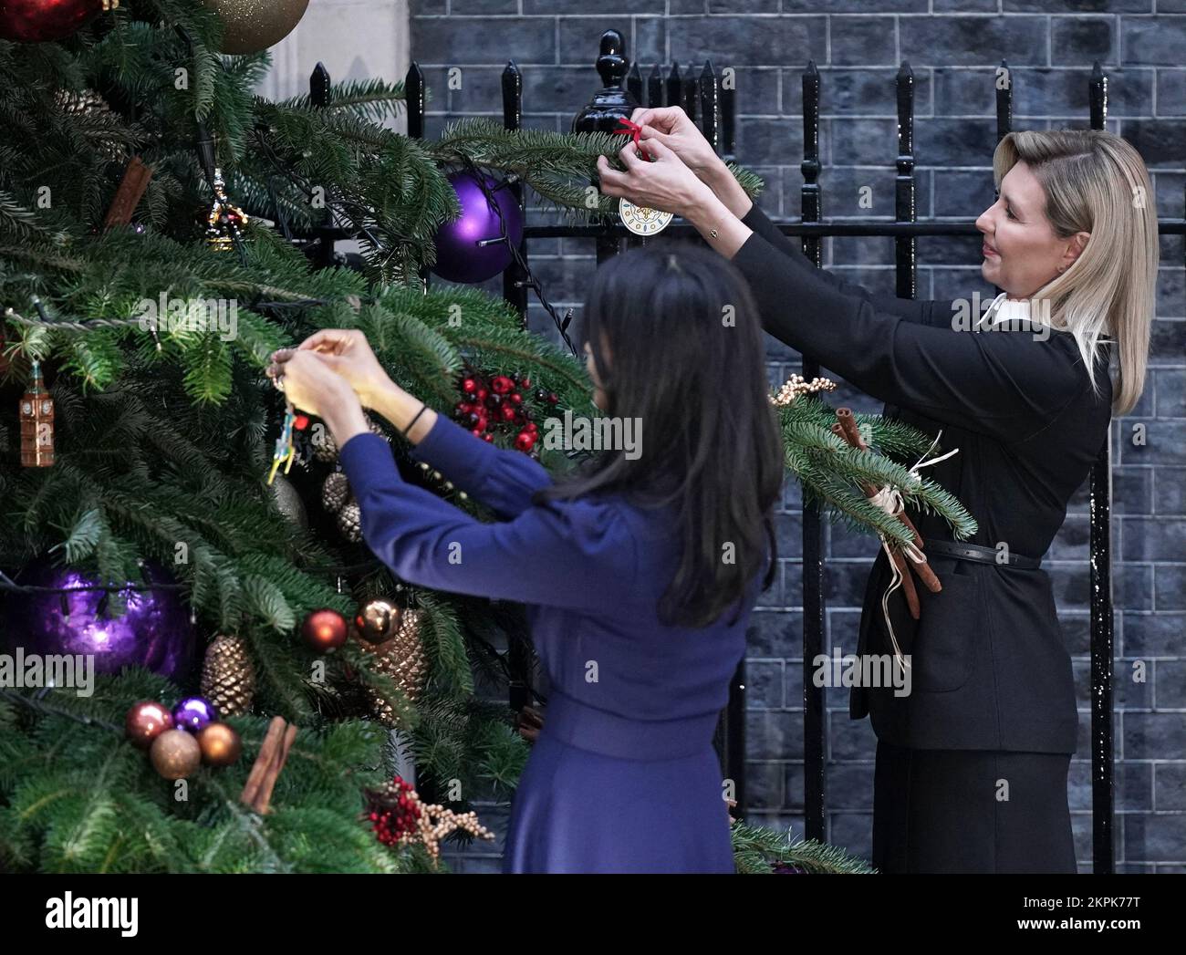 First Lady of Ukraine Olena Zelenska (right) hangs a decoration to the ...