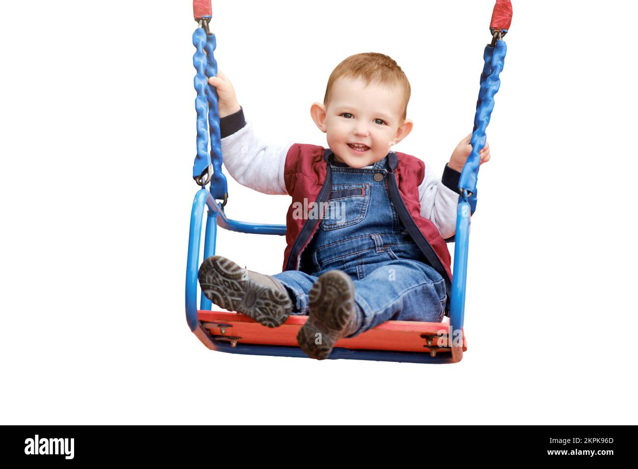 Happy toddler baby boy rides on a swing, isolated on a white background ...