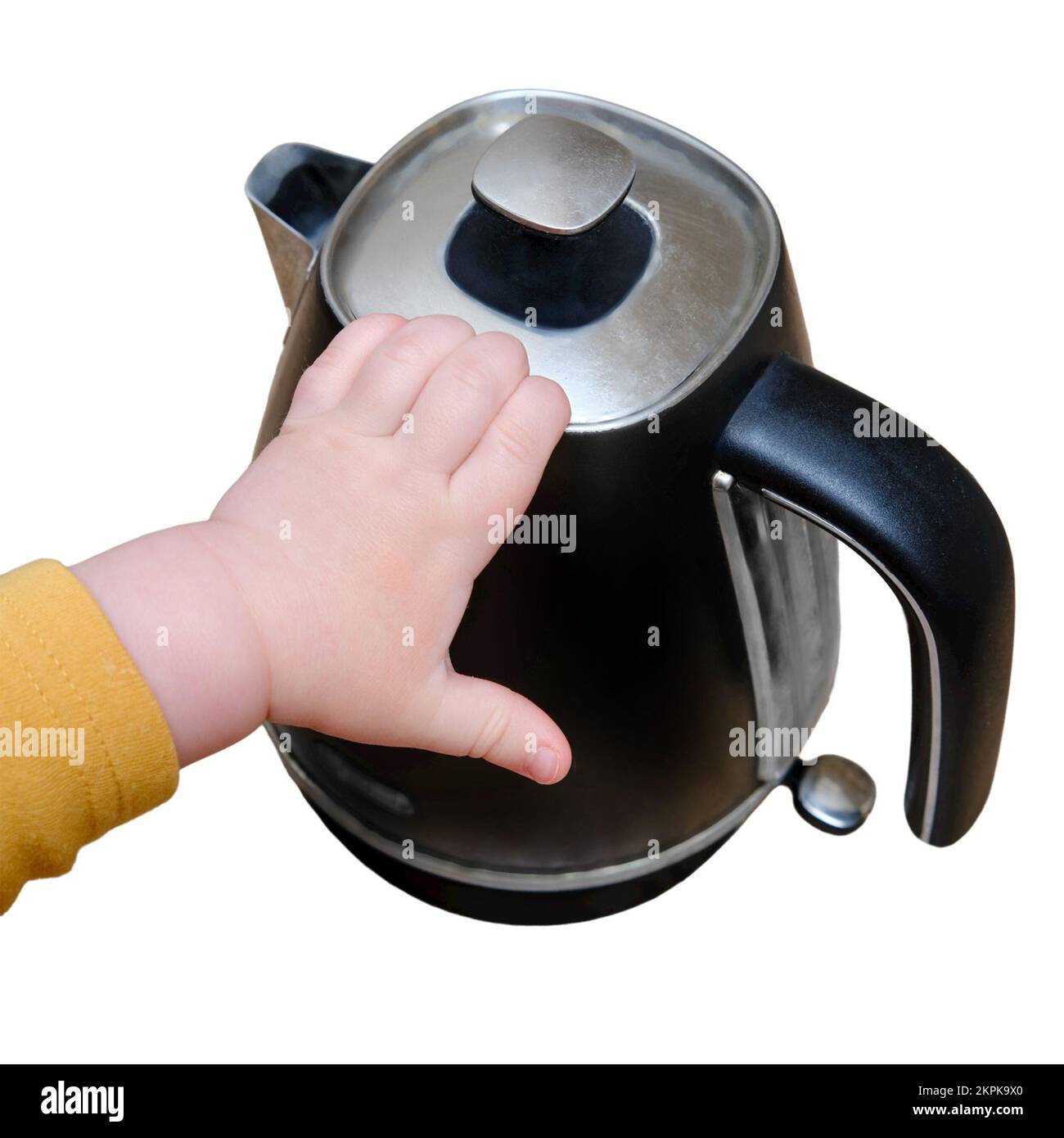 Toddler baby boy holds a hot kettle with boiling water, isolated on a ...