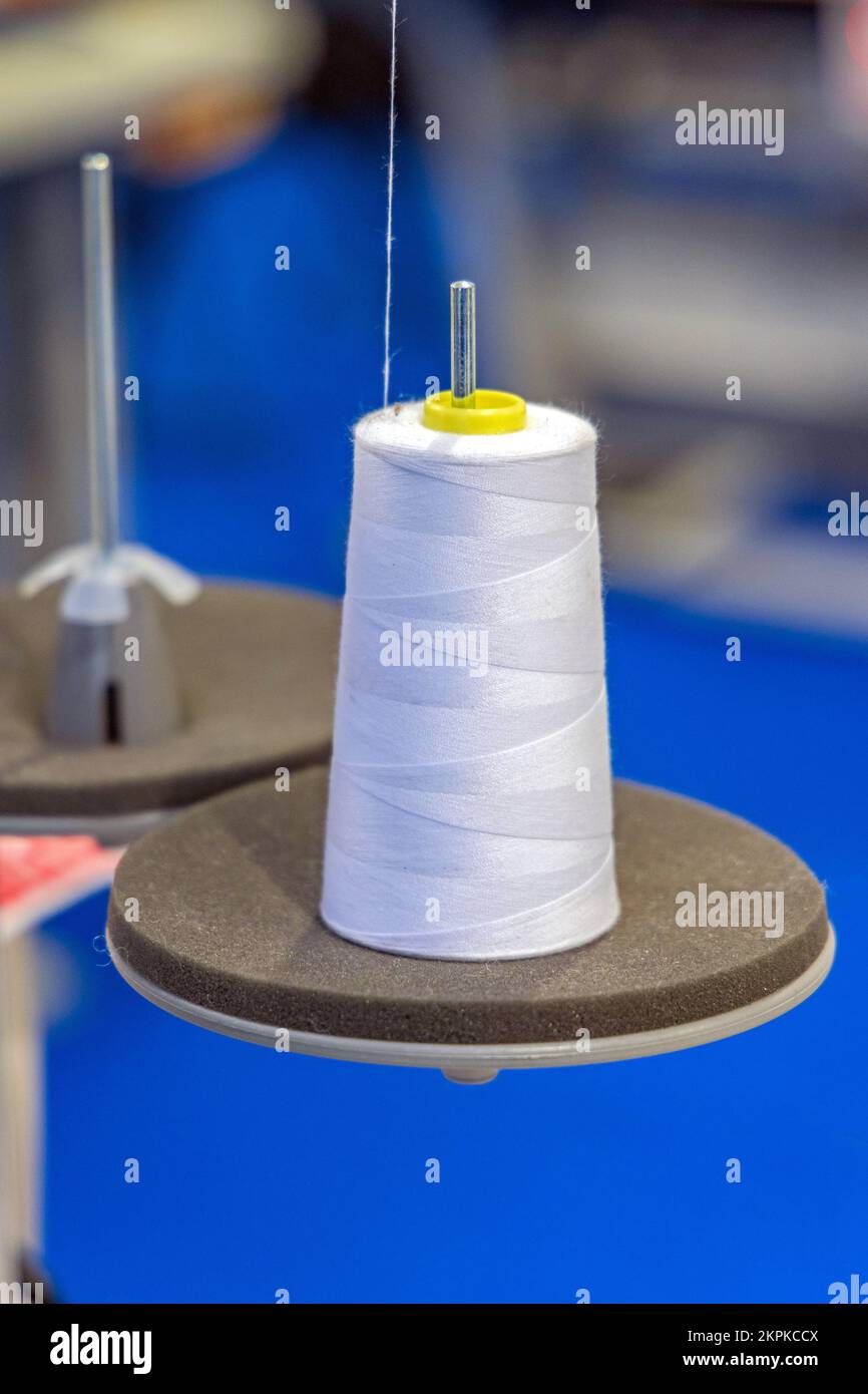 White Thread Yarn Spool Sewing Machine Factory Stock Photo - Alamy