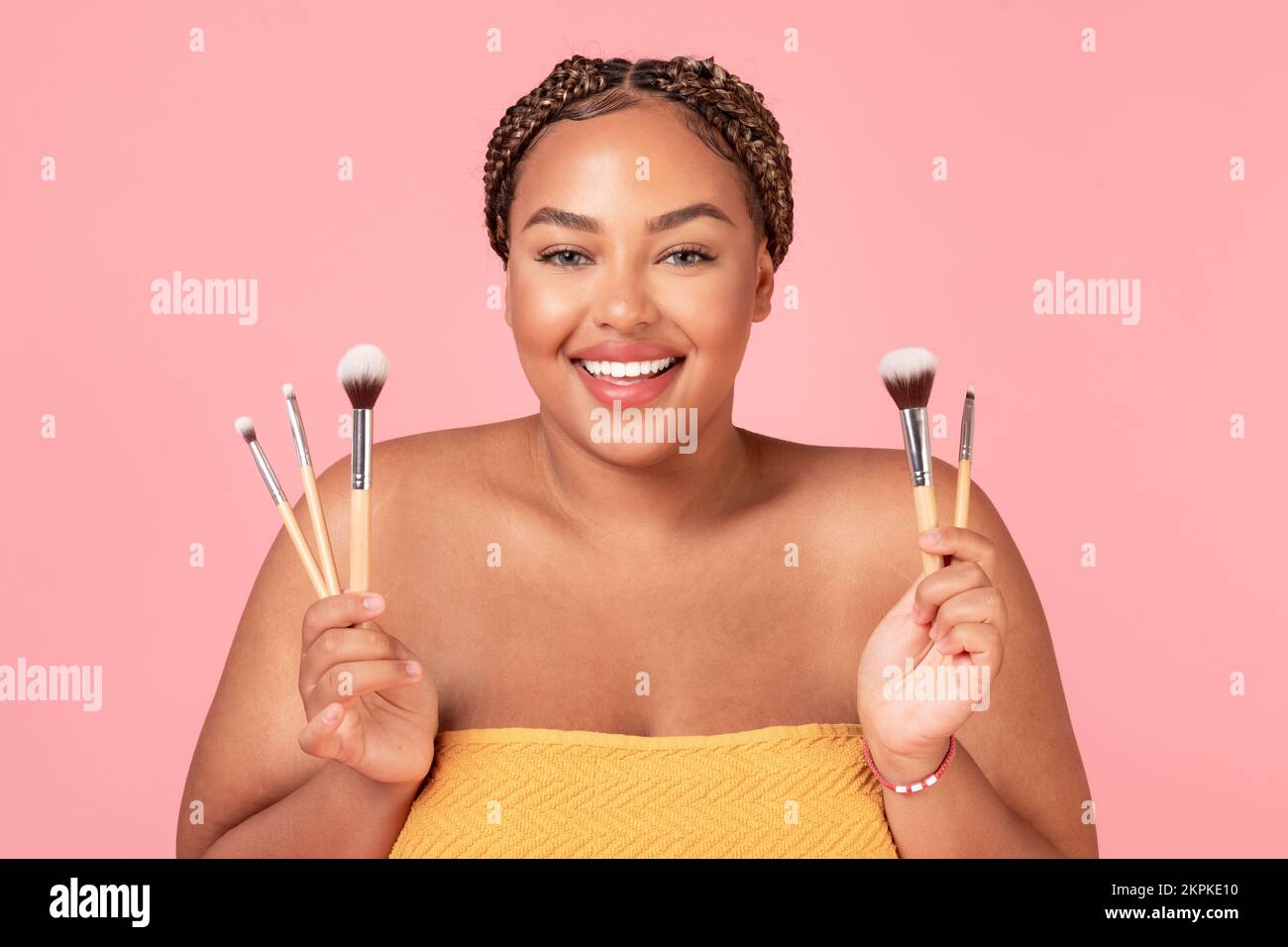 Make up concept. Portrait of beautiful black oversize lady holding ...