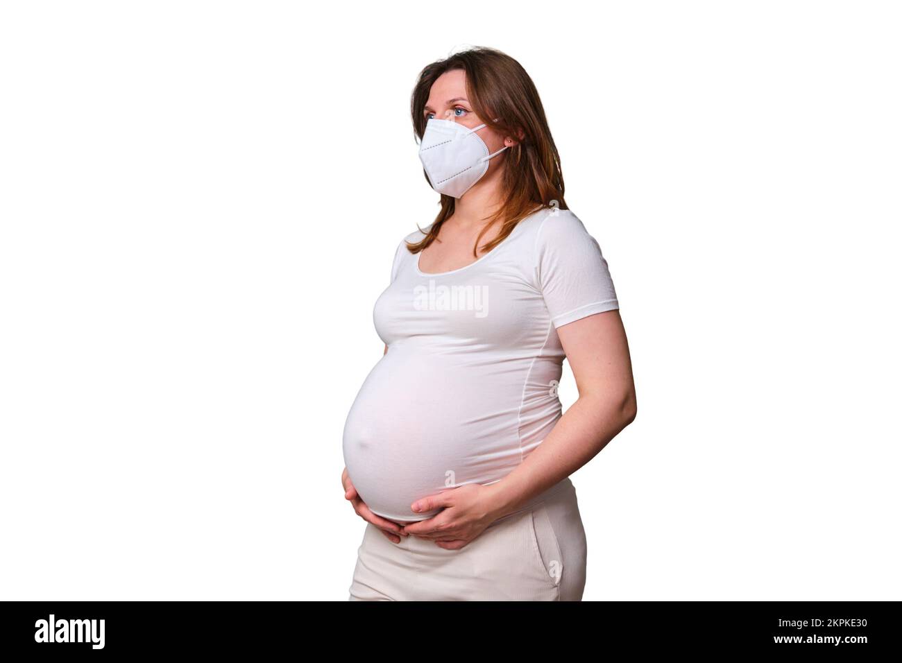 Pregnant woman in medical face mask and white clothes, portrait on ...