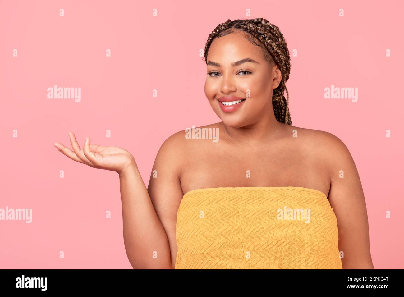 Beauty advertisement. Happy black body positive lady holding something ...