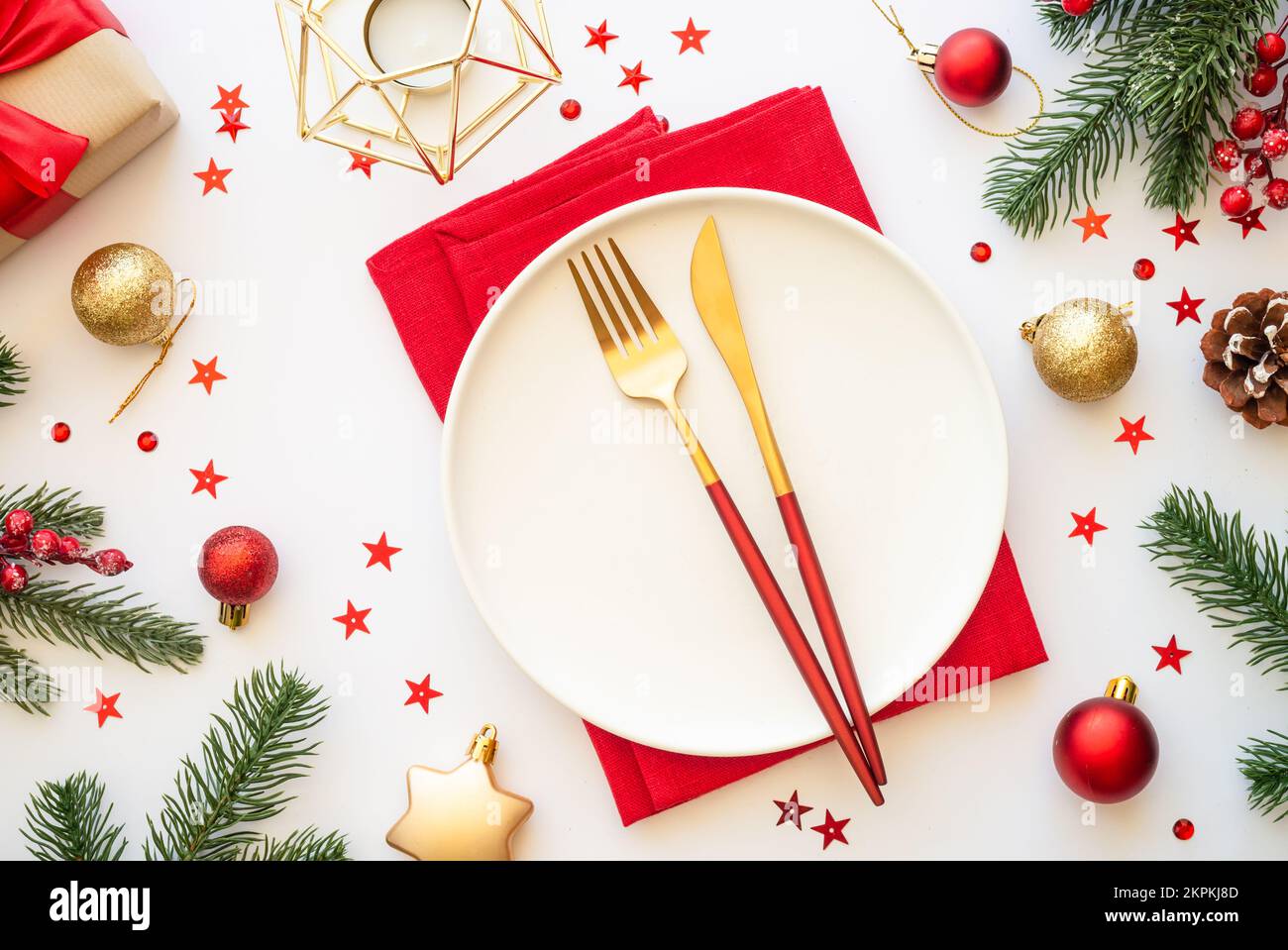 Christmas table setting with plate, cutlery and christmas decorations ...