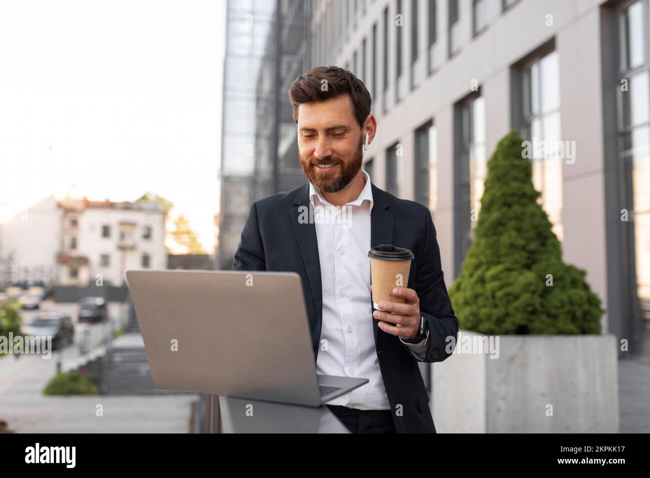 Happy confident young european man boss with beard in suit, wireless ...