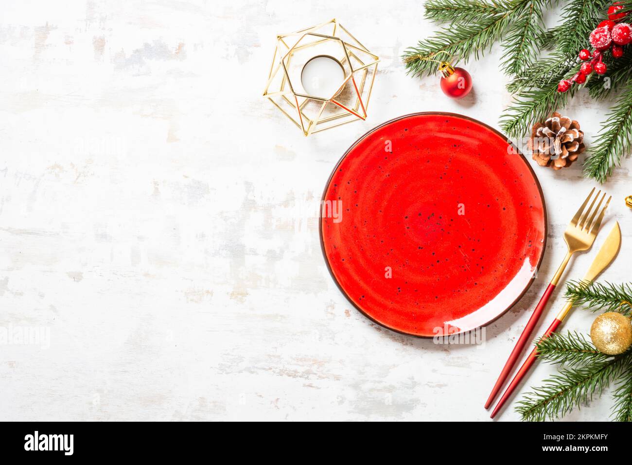 Christmas table setting with plate, cutlery and christmas decorations ...