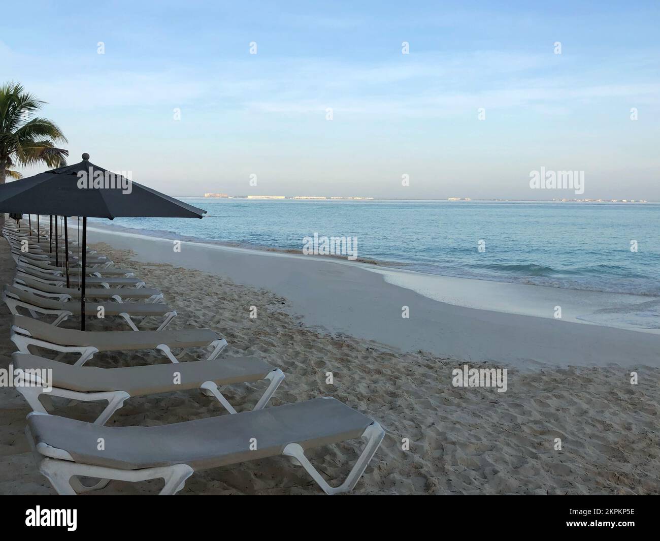 Rows of empty sun loungers on beach in morning, Playa Norte, Isla ...