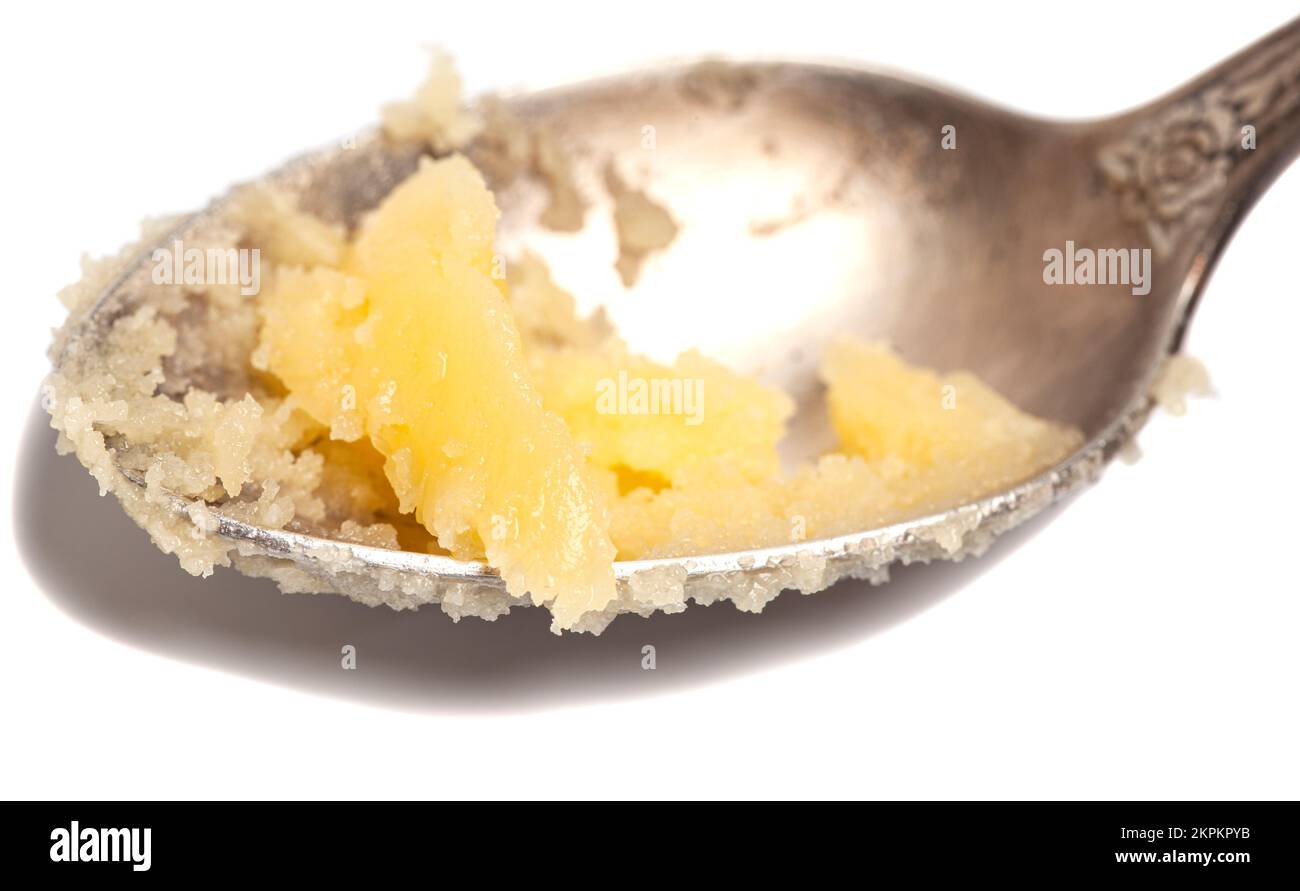 Ghee in spoon isolated on white background Stock Photo - Alamy