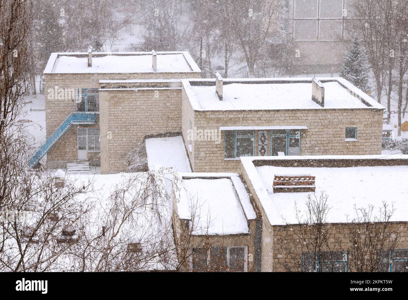 Winter roofs of buildings in a blizzard and trees Stock Photo - Alamy