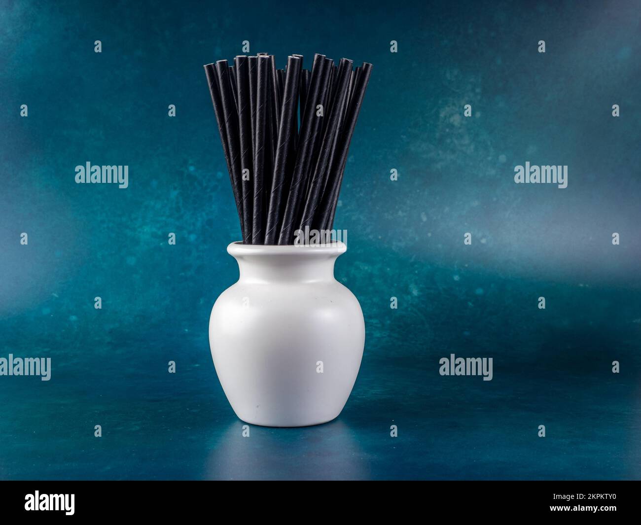 white vase pot containing black bio degradeable bamboo cocktail straws ...