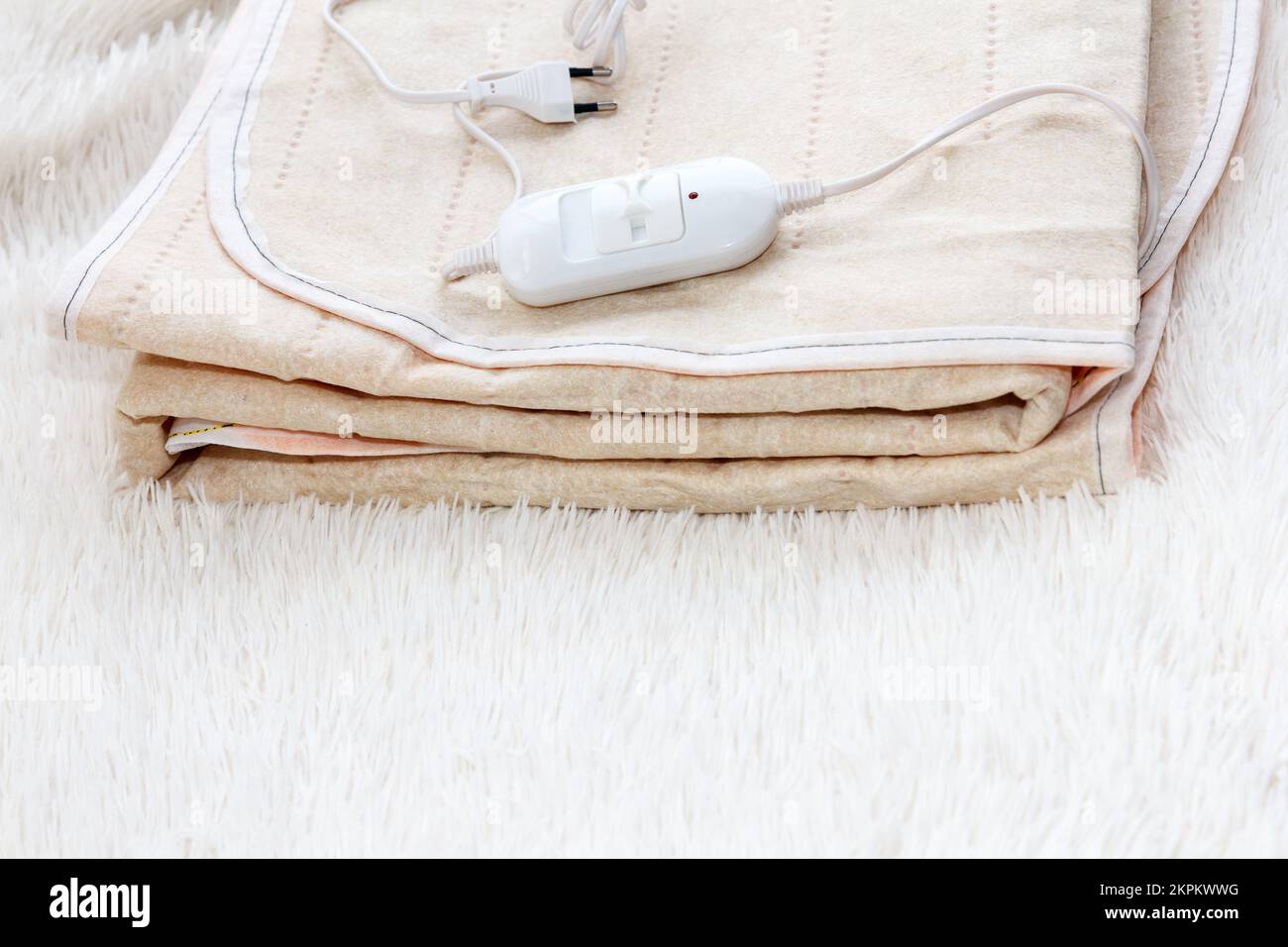 A warm two-sided new electric sheet, lies assembled, and on top of the ...